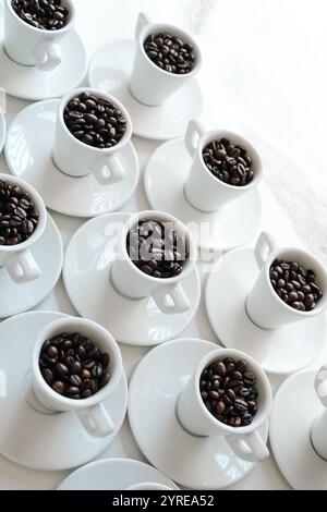 Frothy coffee in white cups, delicious French macaroons. Dessert still ...