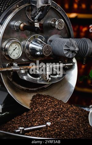Roasted coffee beans with coffee cup setup on dark stone background ...