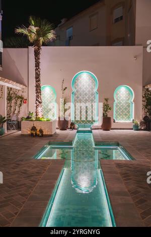 Luxurious Hotel Courtyard at Night with Ornate Balcony and Pool Stock ...