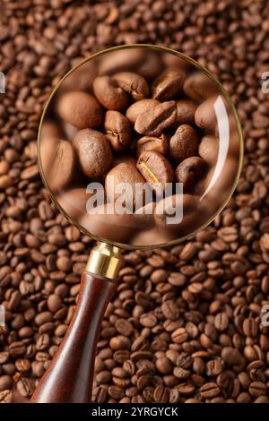 Coffee beans under a magnifying glass. Conceptual image on the theme of ...