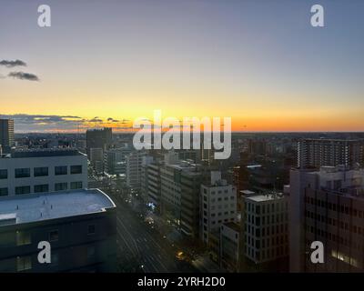 Dawn in Sendai, Japan. The sun can be seen rising from the skyline ...