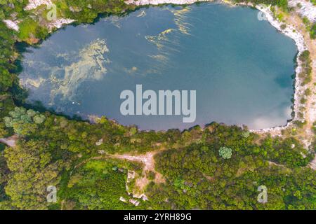 lagoon formed in an abandoned old quarry, zenithal aerial drone view ...
