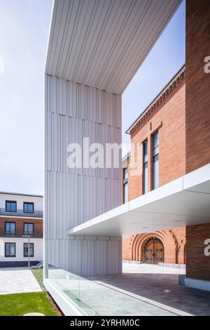 A modern hospital building featuring a blend of brick and glass ...