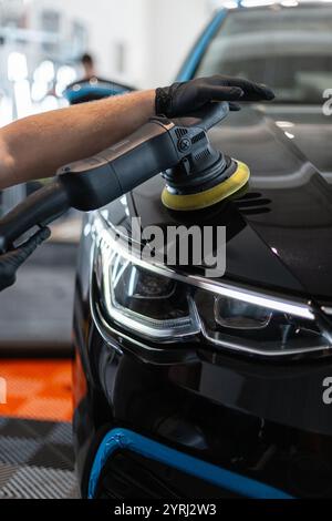 Car detailing studio worker removing scratches and polishing car Stock ...