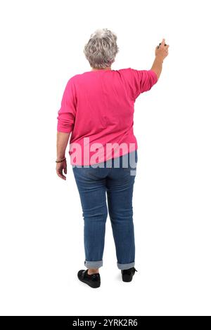 back view of a senior woman spray painting with arms raised on white ...