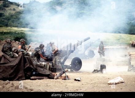 82nd Airborne artillery personnel load and fire M102 105 mm howitzers ...
