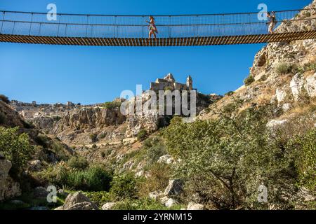People crossing the bridge of the Murgia Materana park (Parco della ...