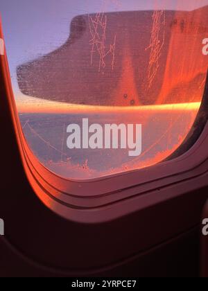 View from airplane window featuring aircraft wing flying high above ...