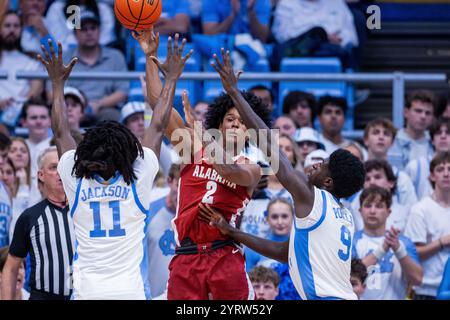 Alabama guard Aden Holloway, center left, looks to shoot past South ...