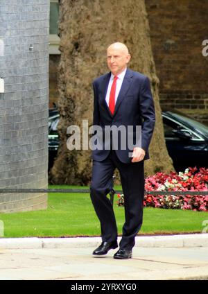 Defence Secretary John Healey standing in between a Mersey Ferry (left ...