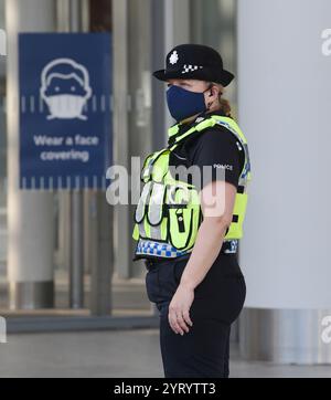Police officers wear face masks to help protect against the spread of ...