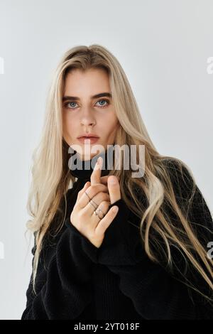 A confident blonde woman models stylish denim, exuding a casual vibe ...