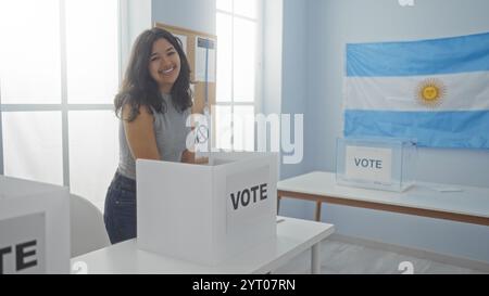Young brunette woman by ballot box holding afghanistan flag smiling ...