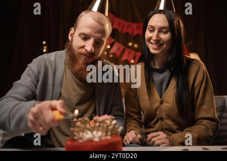 Happy couple celebrating Birthday near brick wall Stock Photo - Alamy