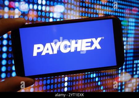 In this photo illustration, the Paychex company logo is seen displayed ...