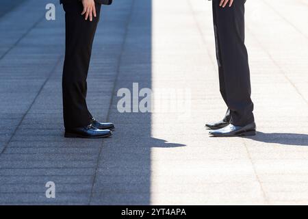 Businessmen's feet facing each other Stock Photo - Alamy