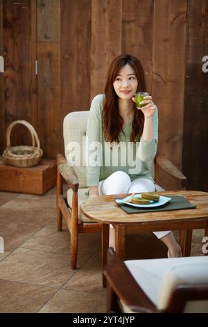 Refreshing woman relaxing at a café Stock Photo - Alamy