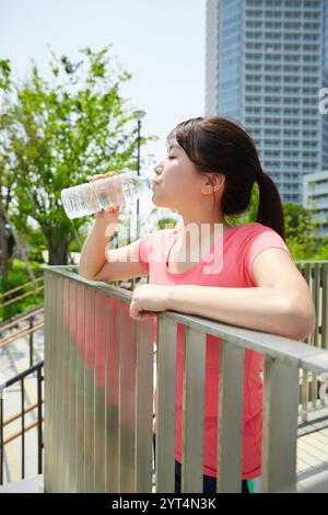 Young women hydrating during exercise Stock Photo - Alamy