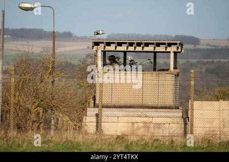 soldier with automatic rifle manning a lookout tower sentry post Stock ...
