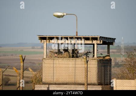 soldier with automatic rifle manning a lookout tower sentry post Stock ...