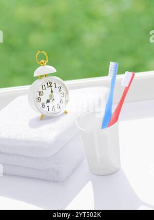 Toothbrush and alarm clock on windowsill Stock Photo - Alamy