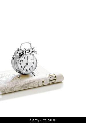 English newspaper and alarm clock Stock Photo - Alamy