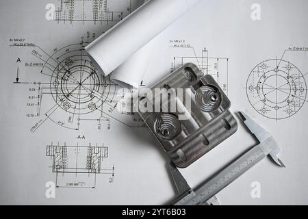 Metal machined part being measured with a caliper, placed on top of ...
