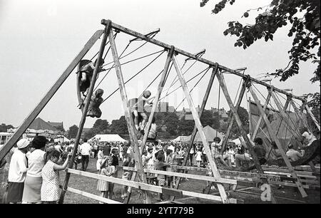 1968, historical, at a country fayre, children enjoying the two-seater ...