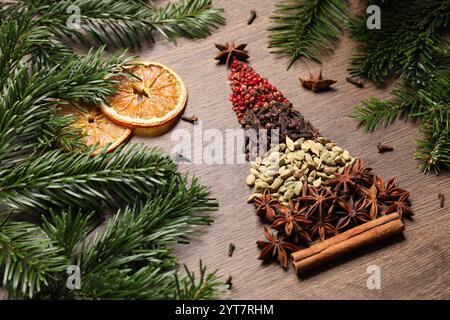 Different spices, dried orange slices and fir tree branches on light ...