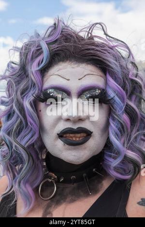 England, Kent, Dover, Drag Artist Walking with Suitcase in the Rain ...