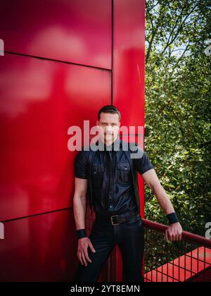 Man in leather outfit on the outside of a building Stock Photo - Alamy