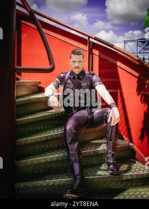 Man in leather outfit on the outside of a building Stock Photo - Alamy