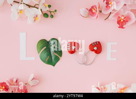 Romantic spring letters made of pink petals, on color wooden background ...