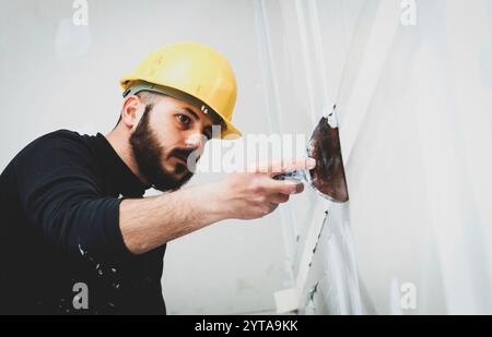 Interior construction, worker plastering gypsum board wall Stock Photo ...