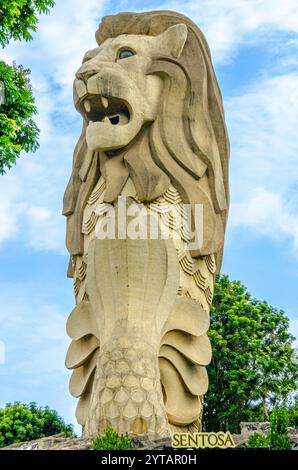 The Merlion, with the head of a lion and the body of a fish, stands as ...