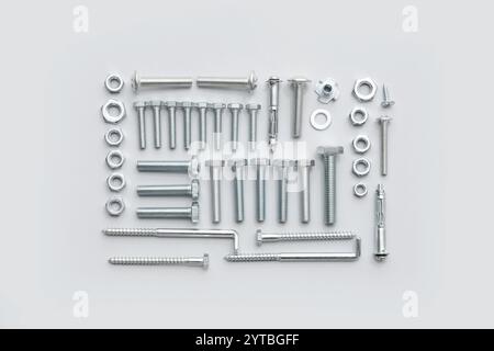 Arrangement of different tap bolts, screws and chrome nuts isolated on ...