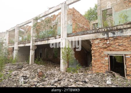 An old, collapsed building of Soviet army base in Latvia, Europe. Red ...