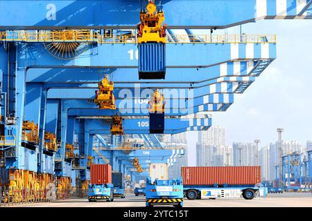 Cargo ships load and unload foreign trade containers at Qingdao Port in ...