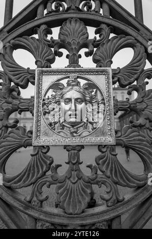 Gold colored bas relief decoration on metal fences Stock Photo - Alamy