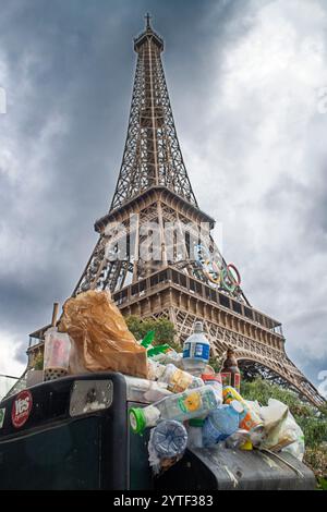 Paris, France. An overflowing rubbish bin on a pavement near the Seine ...