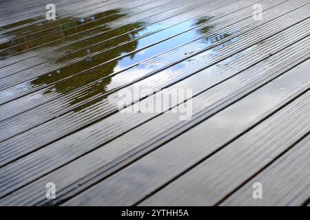 Water pooling forming a puddle on timber decking not draining Stock ...