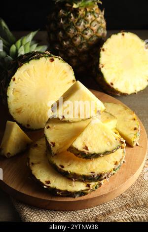 Fresh ripe pineapples on table against grey background Stock Photo - Alamy