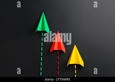 Colorful paper planes with flight paths on blue background. Dashed ...