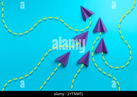 Purple paper planes with flight paths on orange background. Dashed ...