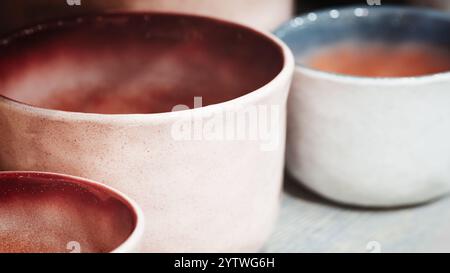 A row of pots with different colors and patterns. The middle pot is the ...