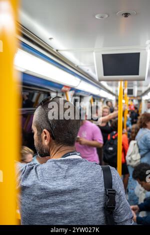 Old man standing in subway car Stock Photo - Alamy