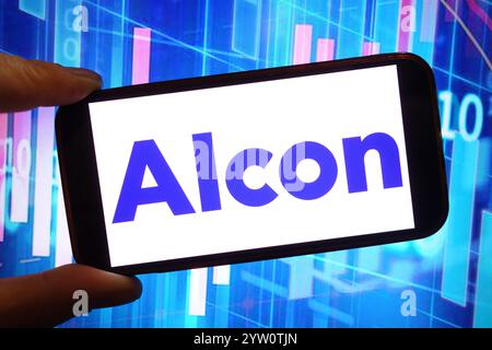 In this photo illustration, the Alcon logo is displayed on a smartphone ...