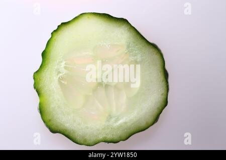 A slim slice of fresh cucumber on white background Stock Photo - Alamy