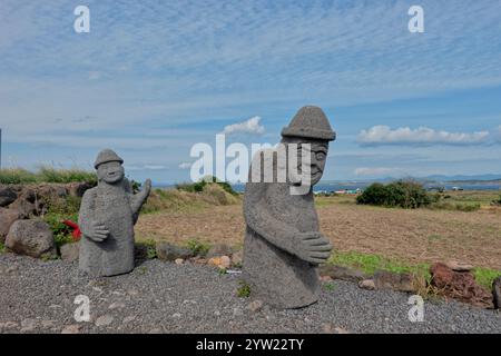 Dol hareubang (grandfather stone) volcanic rock statues along the Jeju ...