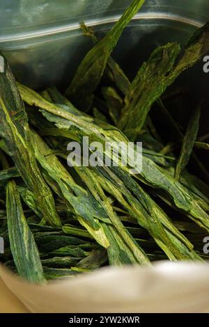 Aromatic and leafy green tea on wooden table. Green leaf tea ready to ...
